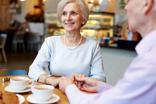유토이미지 | Mature female and her husband holding by hands in cafe