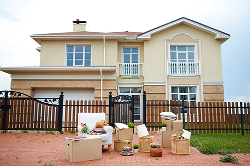 Heap of packed things on asphalt near wooden fence | 유토이미지 | 상세페이지 ...