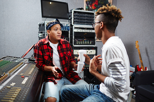 유토이미지 | Two professional sound record operators having talk in audio studio