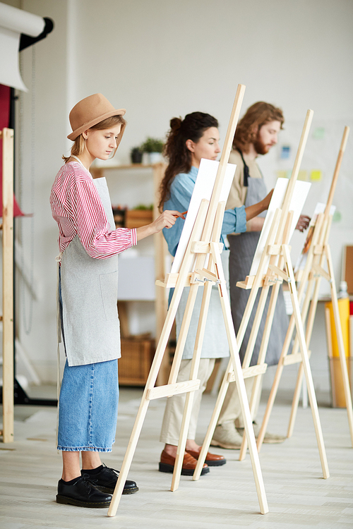 유토이미지 | Young learners standing in front of easels while painting ...
