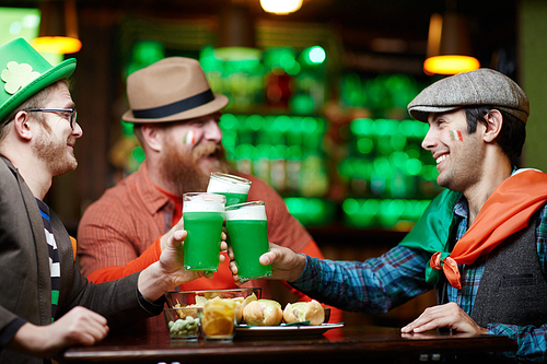 Friendly irish men with beer spending time in pub after football ...