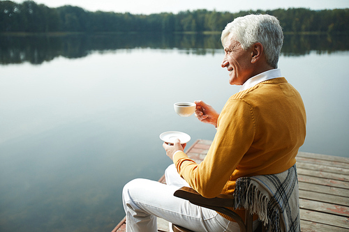 유토이미지 | cheerful dainty handsome man in yellow sweater and white pants ...