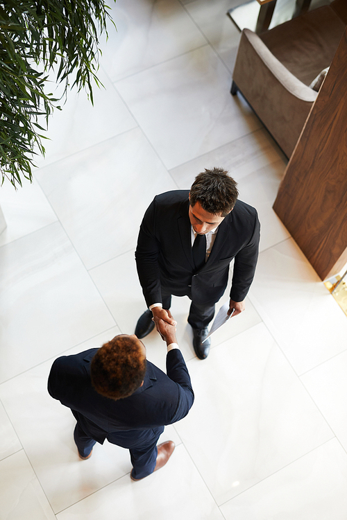 Directly above view of serious confident entrepreneurs in formal suits ...
