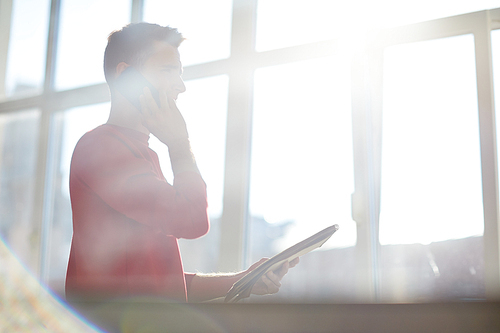 Young businessman talking to client or colleague on smartphone in ...