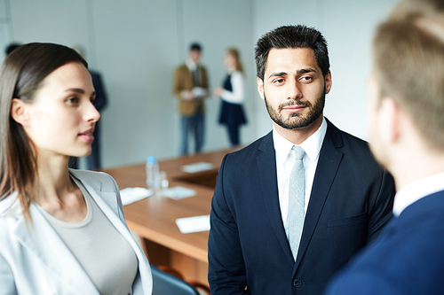 유토이미지 | Group of three young delegates in formalwear having discussion ...