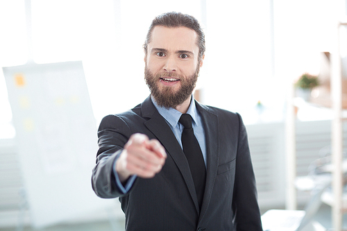 Portrait of businessman pointing at you. He is standing at office | 유토 ...