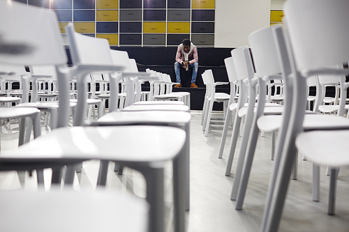 Pensive student sitting in conference-hall | 유토이미지 | 상세페이지 | 베이직샵 | 사진 ...