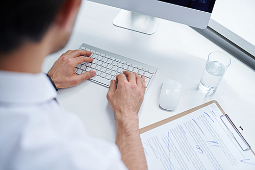 유토이미지 | Hands of young analyst or broker touching keys of computer keypad while working over new ...
