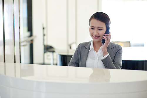 Vietnamese young female receptionist talking on phone | 유토이미지 | 상세페이지 ...