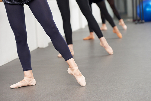 유토이미지 | Ballerinas pointing toes when performing exercise at handrail