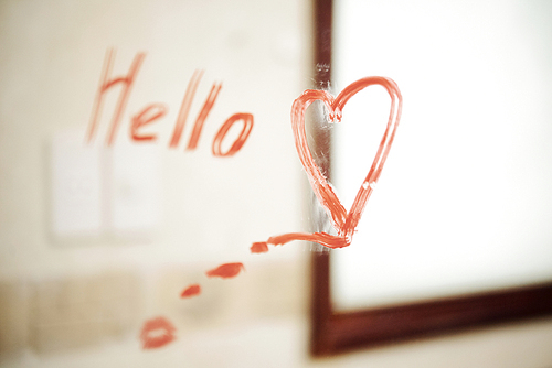 Close-up of message Hello with heart shape written with red lipstick on ...