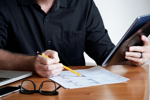 Close-up view of unrecognizable male office worker sitting at office ...