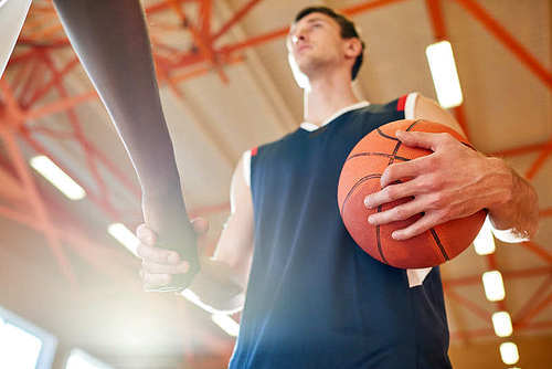 Anonymous basketball players standing on court before match and ...