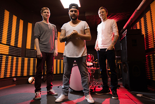 유토이미지 | Full length portrait of modern music band posing in dim ...