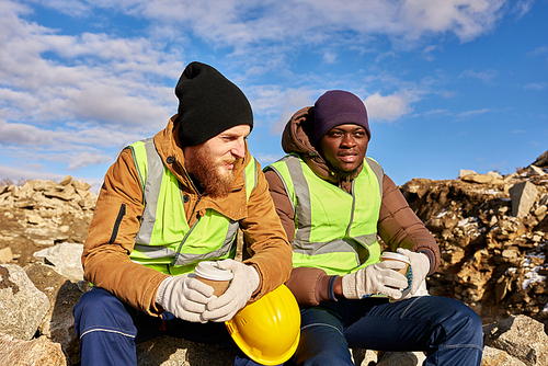 Portrait of two industrial workers wearing reflective jackets, one of ...