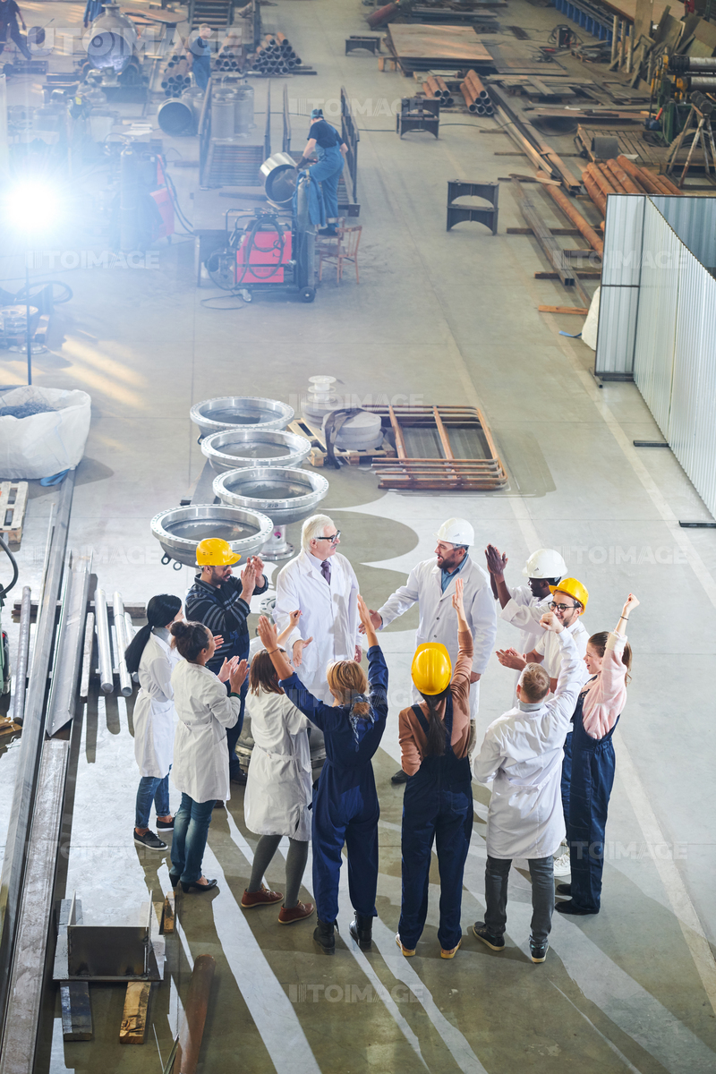 Above view of factory workers protesting during meeting with management ...