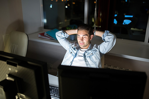 High angle portrait of handsome man chilling while using computer ...