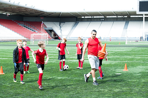 Full length portrait of junior football team practice, group of boy ...