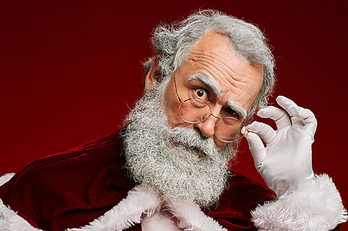 유토이미지 | Head and shoulders portrait of suspicious Santa Claus adjusting ...