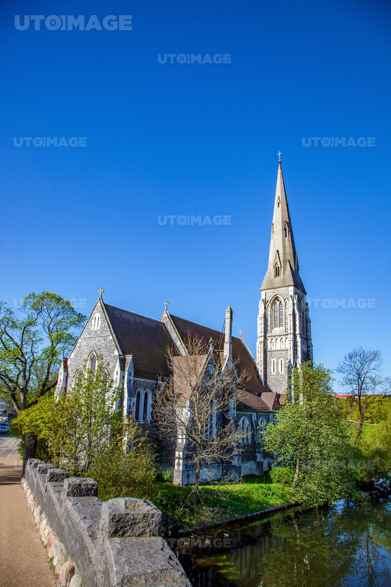 calm pond near beautiful old church at sunny day, copenhagen, denmark ...