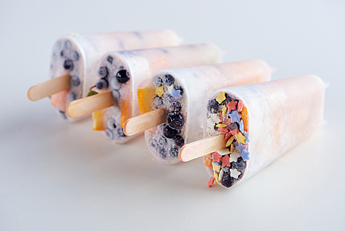 close-up view of fresh frozen homemade popsicles with fruits and ...