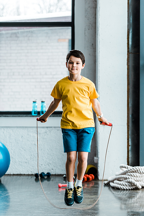 Brunette boy in yellow t-shirt jumping with skipping rope | 유토이미지 | 상세 ...