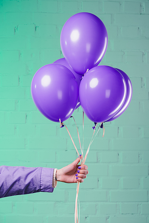cropped shot of woman holding purple helium balloons | 유토이미지 | 상세페이지 ...