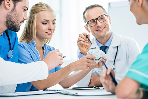 happy team of doctors and general practitioner having conversation and ...