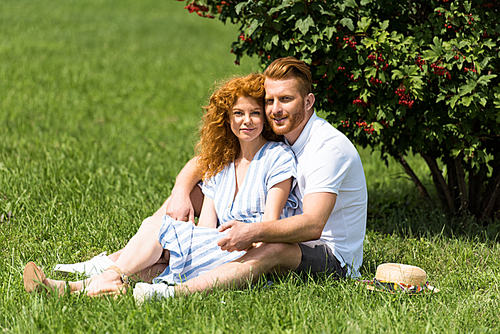 유토이미지 | redhead couple and sitting on grass in park