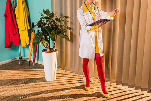 cropped image of retro styled doctor in colorful dress and tights ...