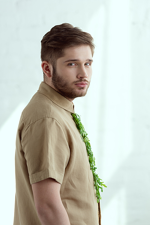 side view of young man with tie made of arugula , vegan lifestyle ...