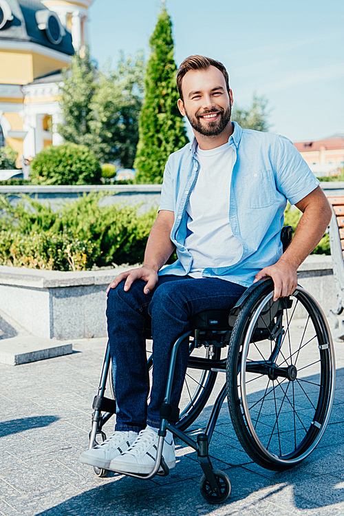 유토이미지 | smiling handsome man in wheelchair on street