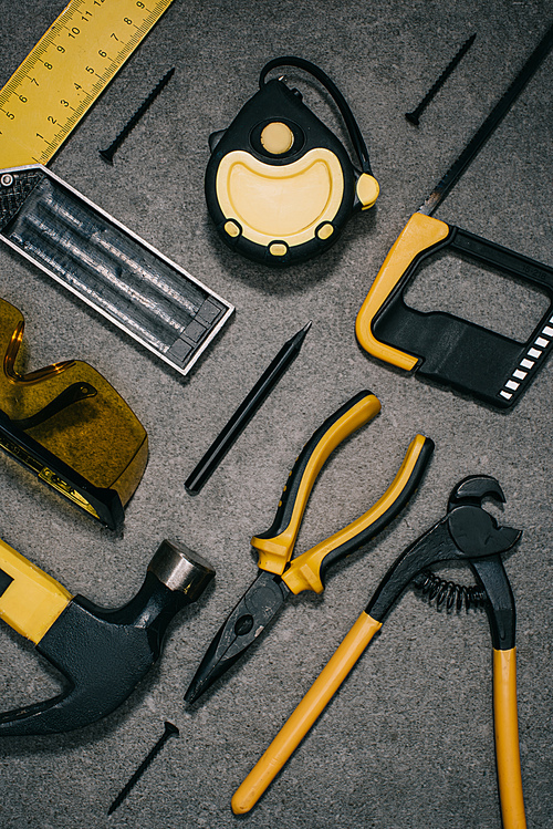유토이미지 | top view of hammer, hacksaw, pliers and tools on grey surface