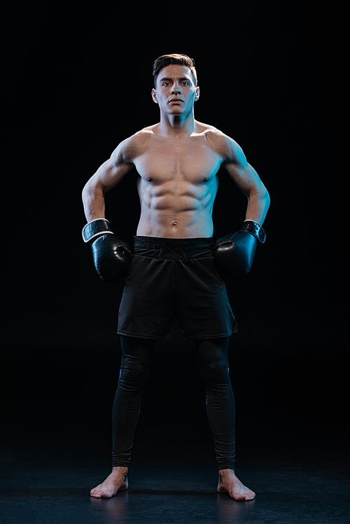 confident muscular barefoot boxer in boxing gloves posing on black | 유토 ...