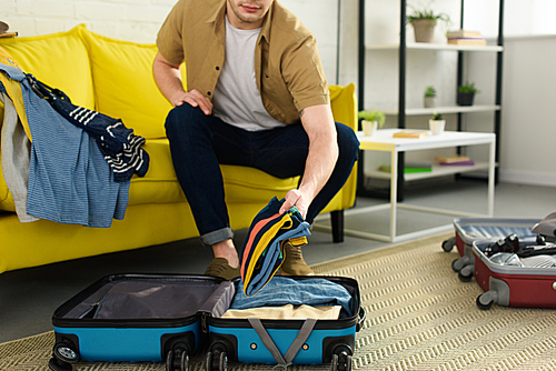 유토이미지 | cropped view of young man packing travel bags