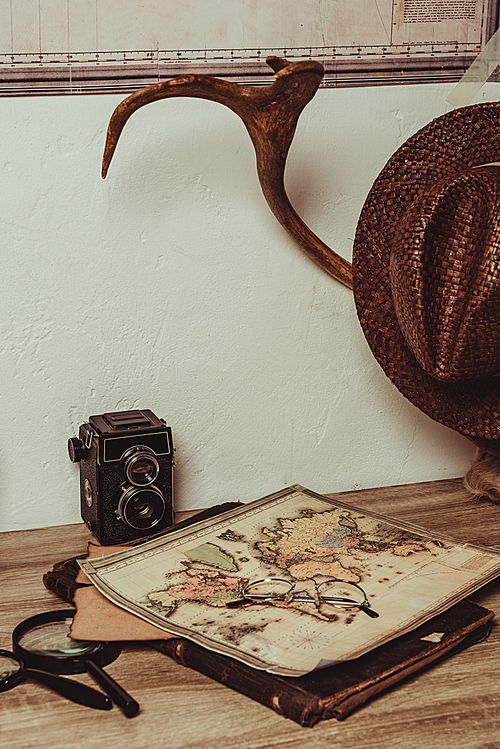 유토이미지 | close up view of table with map, eyeglasses, magnifying glasses ...