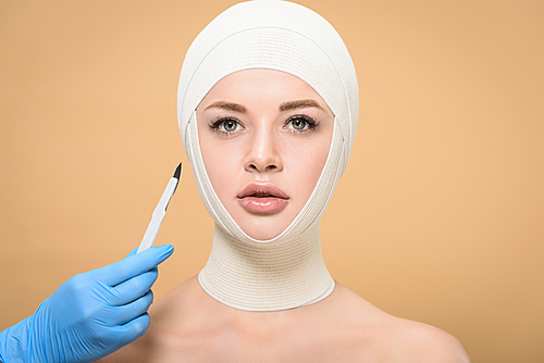 유토이미지 | cropped shot of doctor holding scalpel near woman with bandages ...