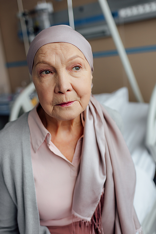 유토이미지 | sad senior woman with cancer sitting on bed in hospital and ...