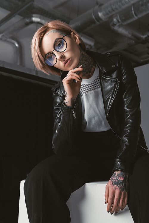 유토이미지 | stylish pensive young woman in eyeglasses and leather jacket ...