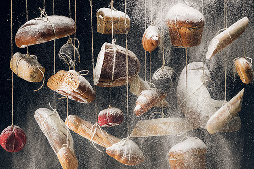 유토이미지 | flour falling at white and brown bread and pastry hanging on ropes
