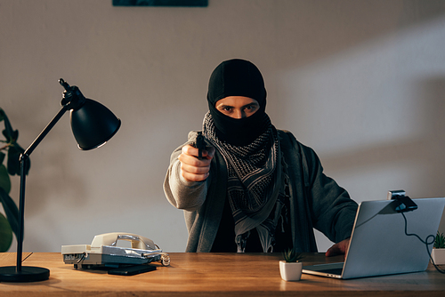 Angry terrorist in black mask aiming gun at camera | 유토이미지 | 상세페이지 ...