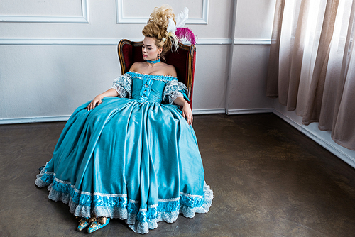 pompous victorian woman in blue dress sitting on antique chair | 유토이미지 ...