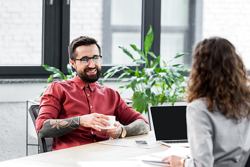 유토이미지 | selective focus of smiling account manager looking at colleague ...