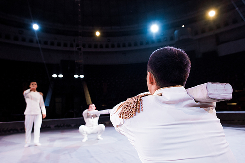 유토이미지 | selective focus of acrobat holding pole near men in circus