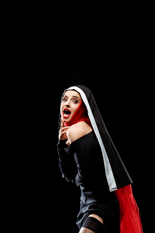 유토이미지 | shocked nun posing in black dress, stockings and red scarf ...
