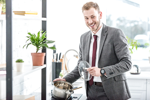 smiling businessman in formal wear holding pot and getting ready to ...
