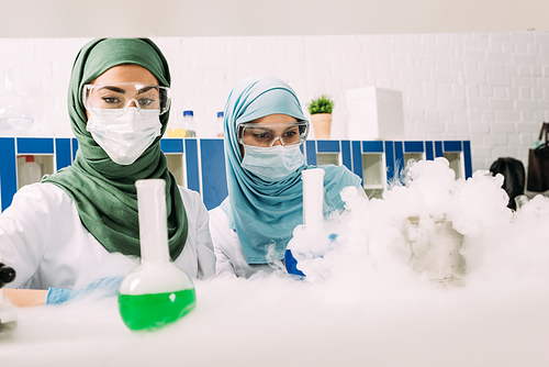 유토이미지 | focused female muslim scientists during experiment with dry ice ...