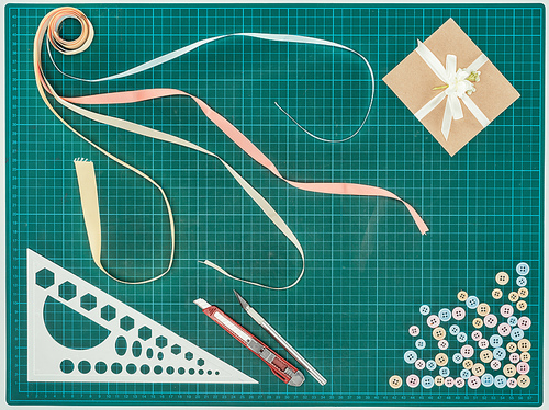 Top view of scrapbooking postcard with ruler and buttons on turquoise ...