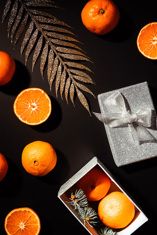 top view of fresh tangerines, decorative twig and silver gift box on ...