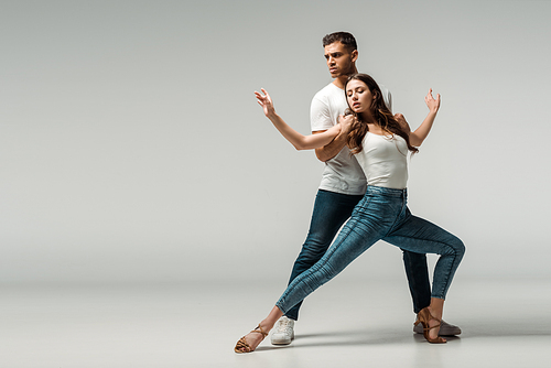 dancers in denim jeans dancing bachata on grey background | 유토이미지 | 상세 ...